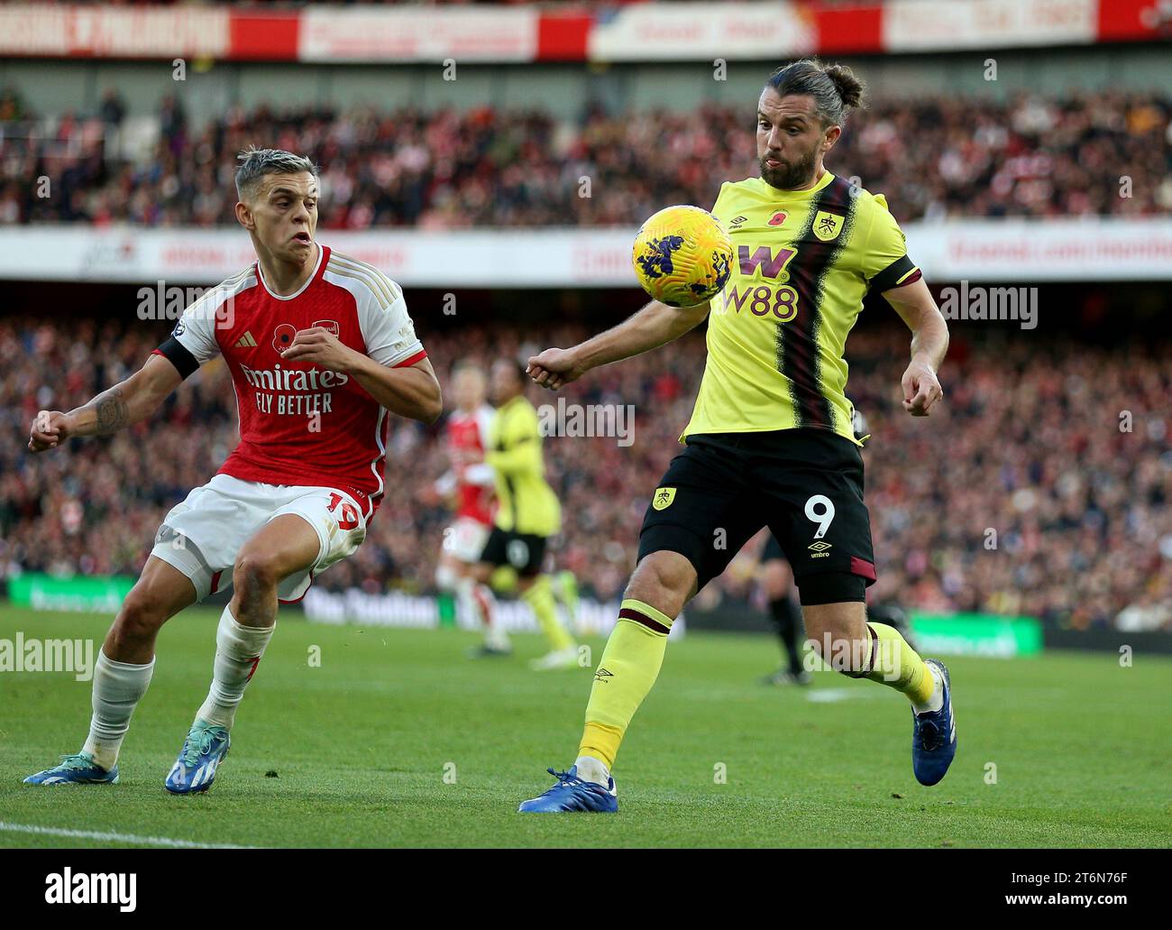 Arsenal's Leandro Trossard (left) and Burnley's Jay Rodriguez battle ...