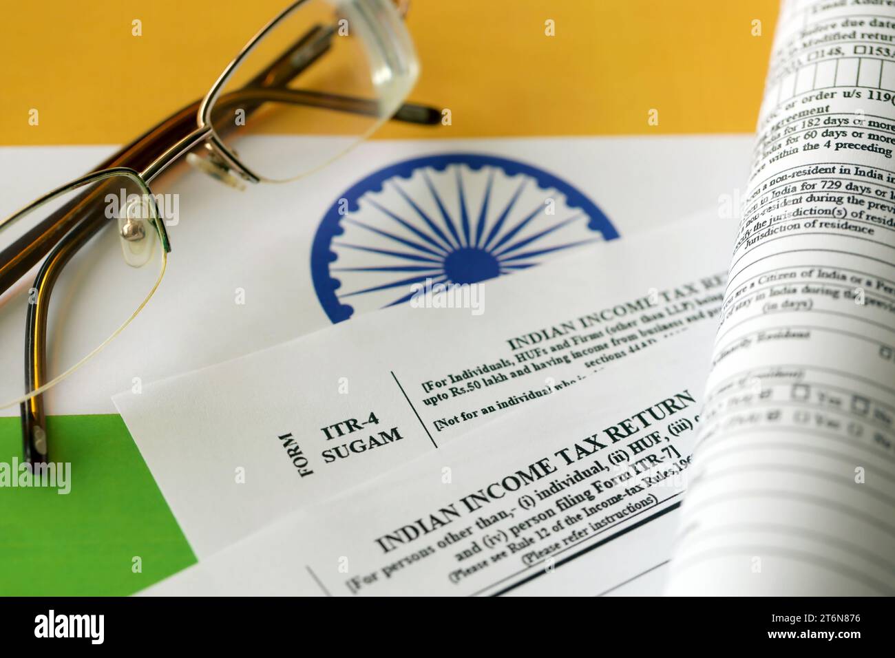 Indian income tax return blank form with pen and indian rupees bills on ...