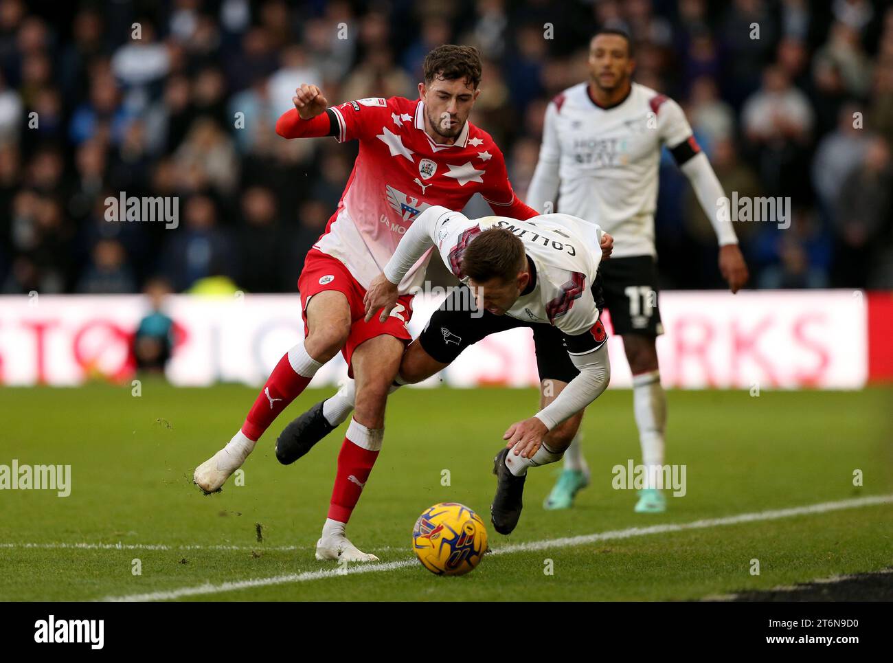 Barnsley's Corey O'Keeffe (left) and Derby County's James Collins ...