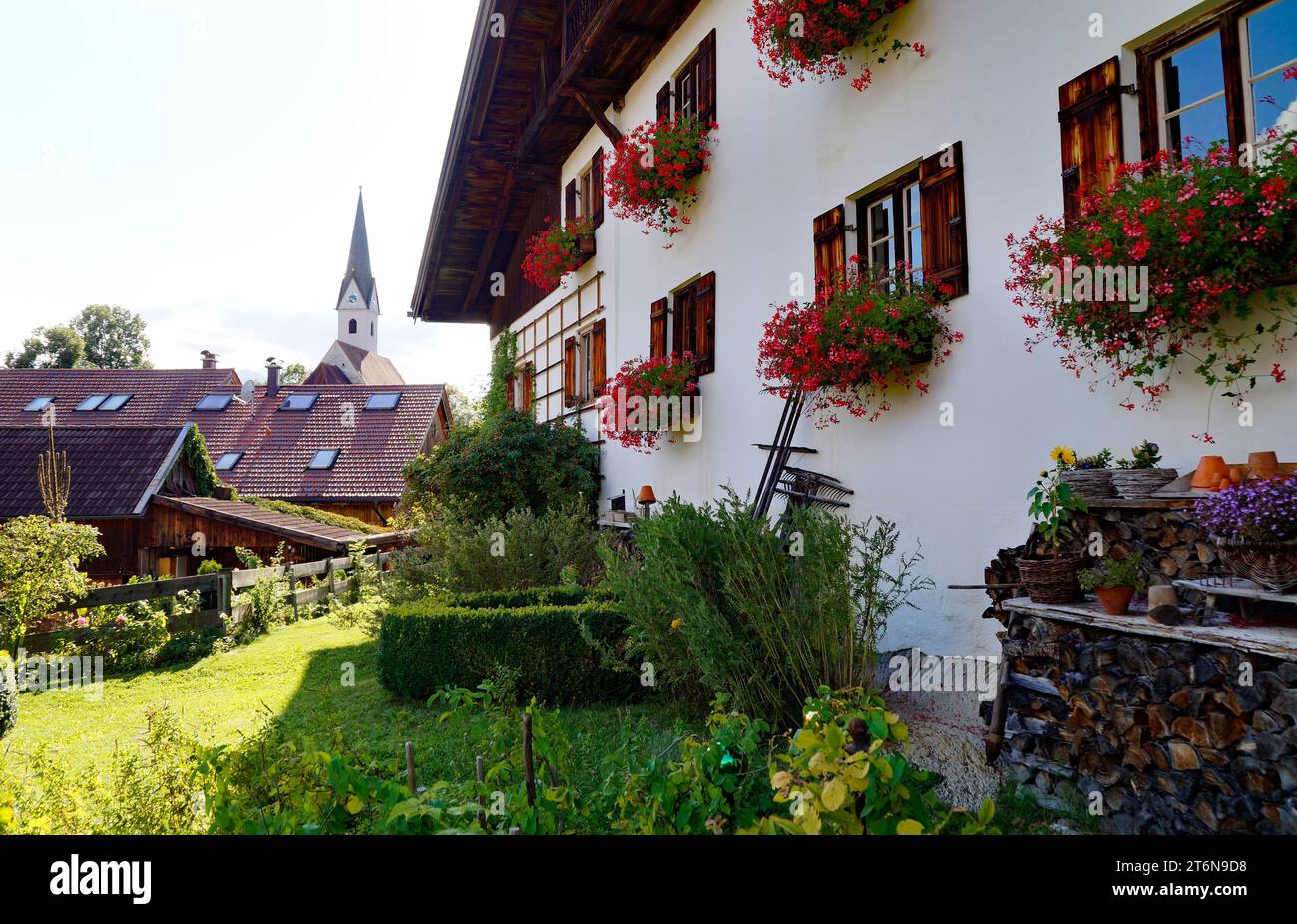 idyllic scene with a traditional Bavarian rustic alpine farmhouse with ...