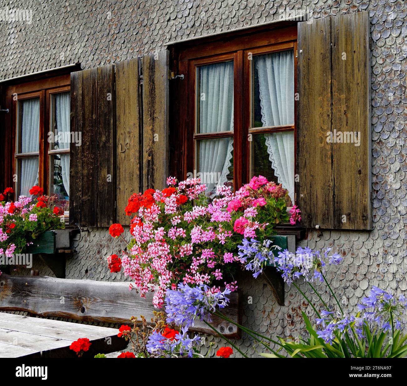 traditional Bavarian alpine country house covered with wood shingles ...