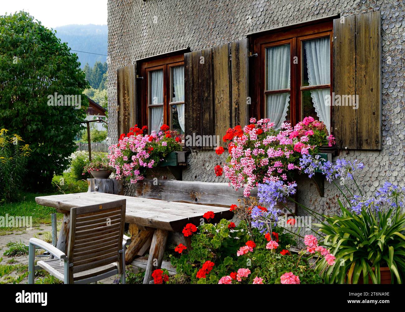 traditional Bavarian alpine country house covered with wood shingles ...