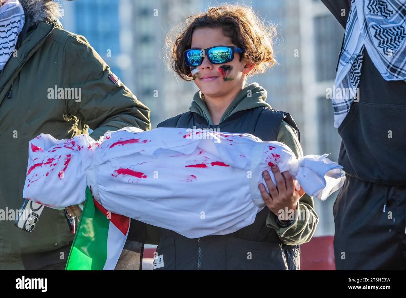 An object is carried in a bloody sheet to represent the killed children ...