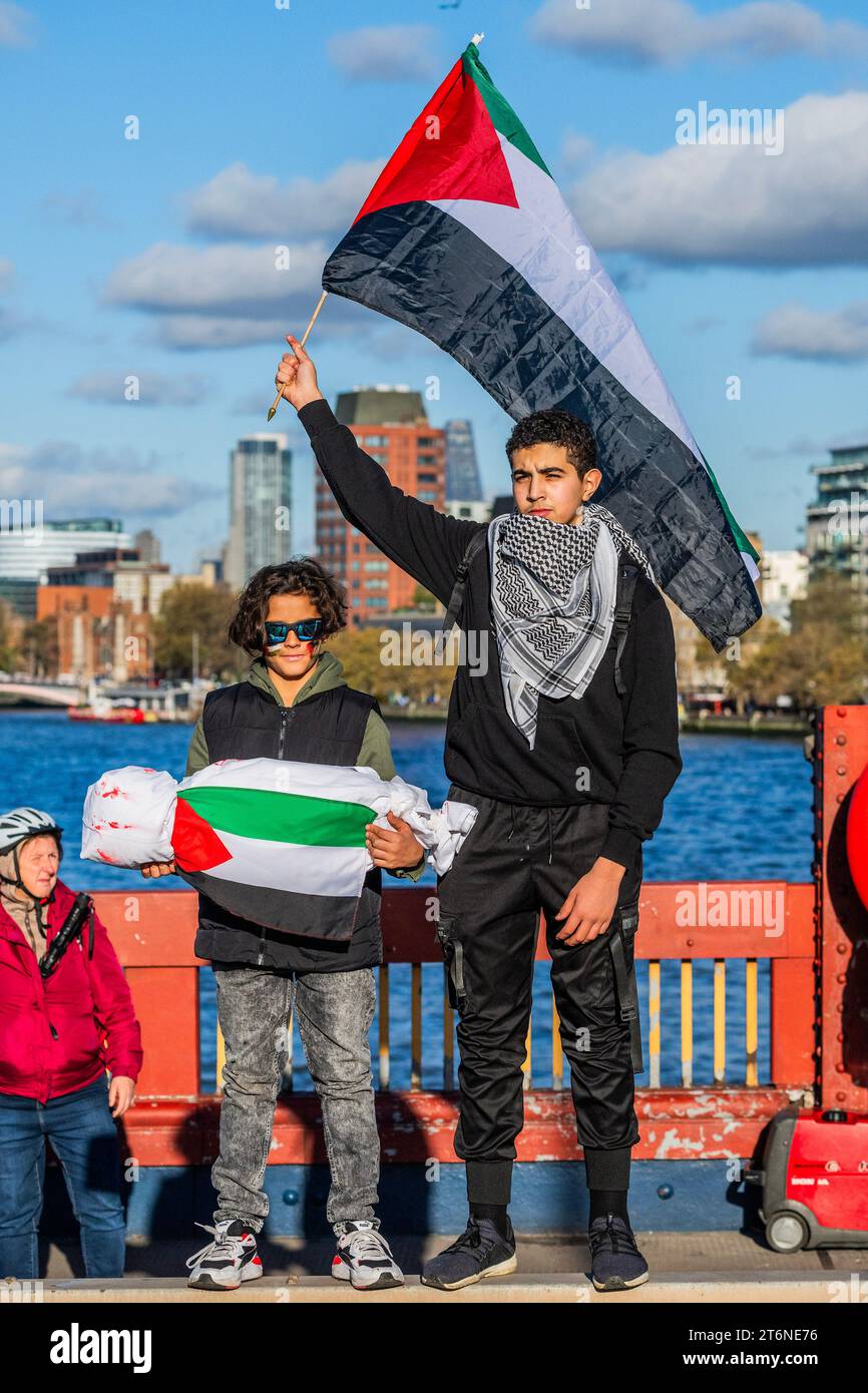 London, UK. 11 Nov 2023. An object is carried in a bloody sheet to ...