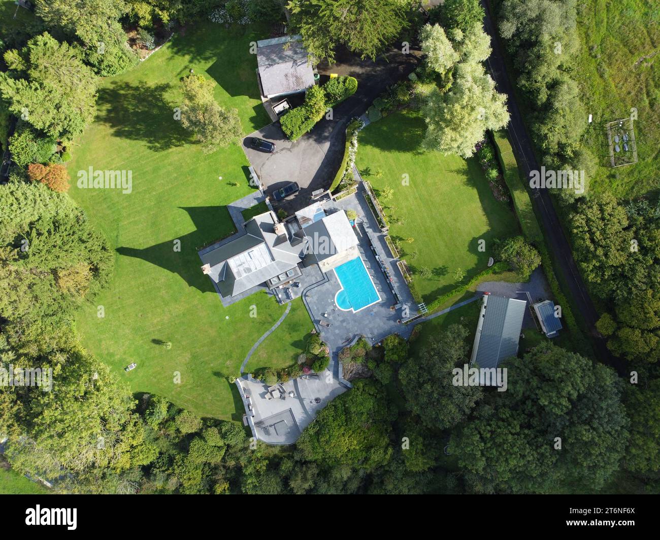 Aerial view of a large rural mansion with a swimming pool in the ...