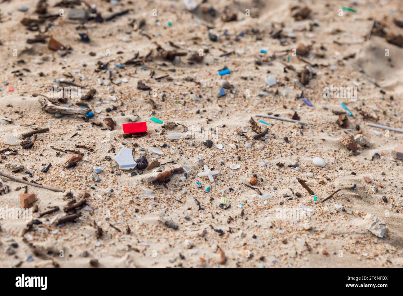 Plastic trash in sand on ocean beach. Pollution by microplastic rubbish ...