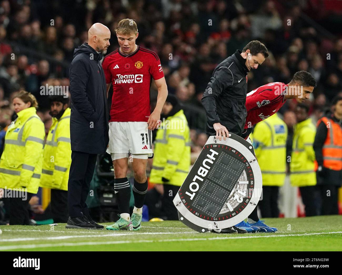 Manchester United's Rasmus Hojlund walks by manager Erik ten Hag after he goes off with an ...