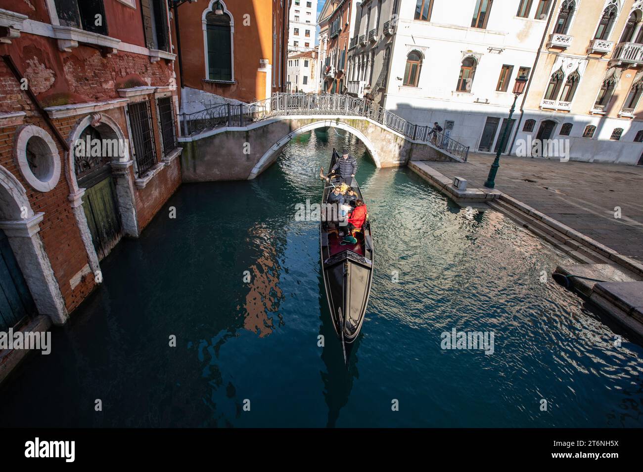 Venice, Italy. Tourists riding in gondola at a Canal exploring Venice ...