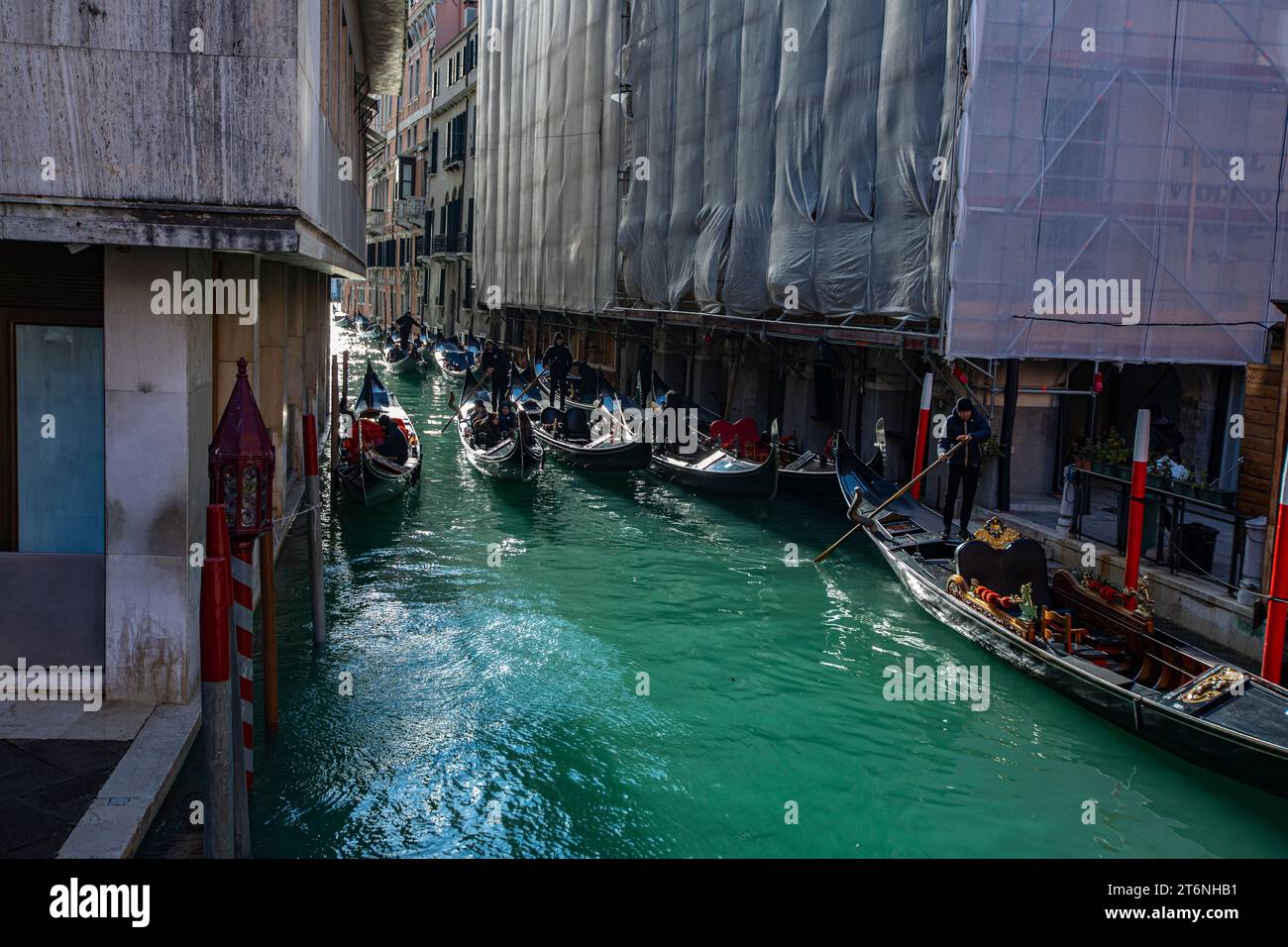 Venice, Italy. Tourists riding in gondola at a Canal exploring Venice ...