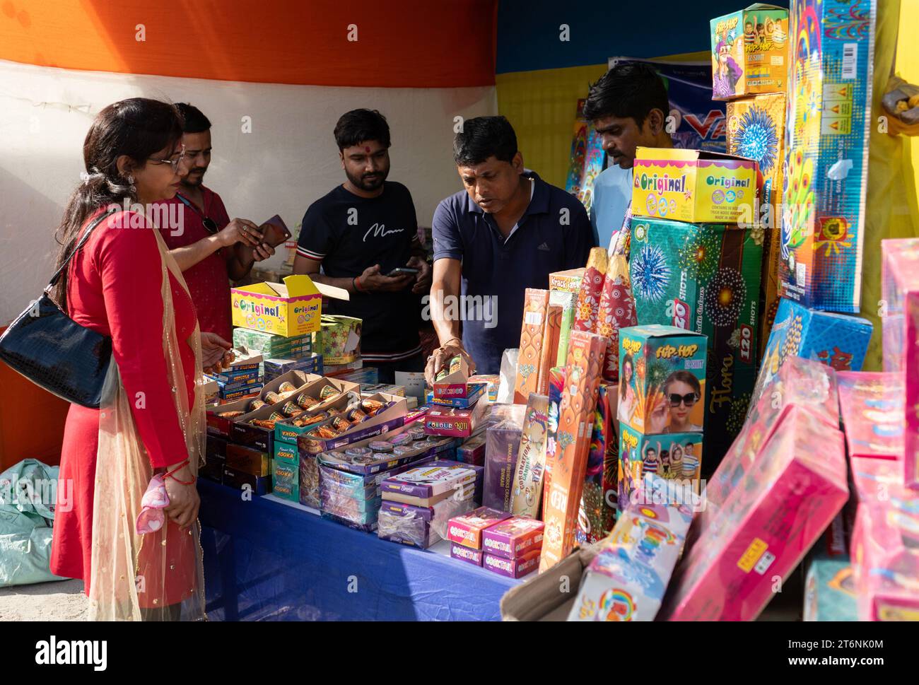 People buys firecrackers in a street market, on the occasion of Diwali ...
