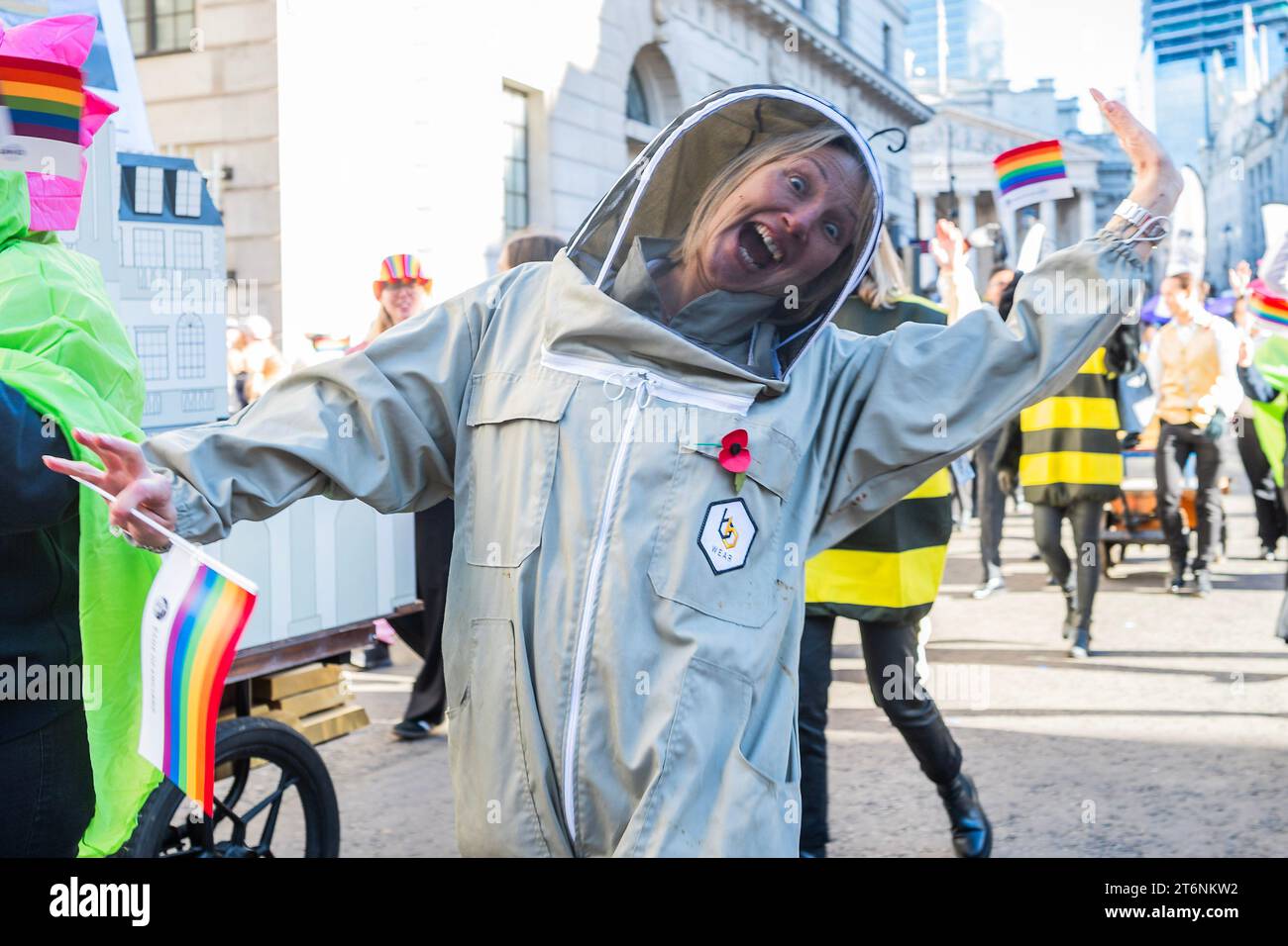 London, UK. 11 Nov 2023. A bee keeper with a bank of england float ...