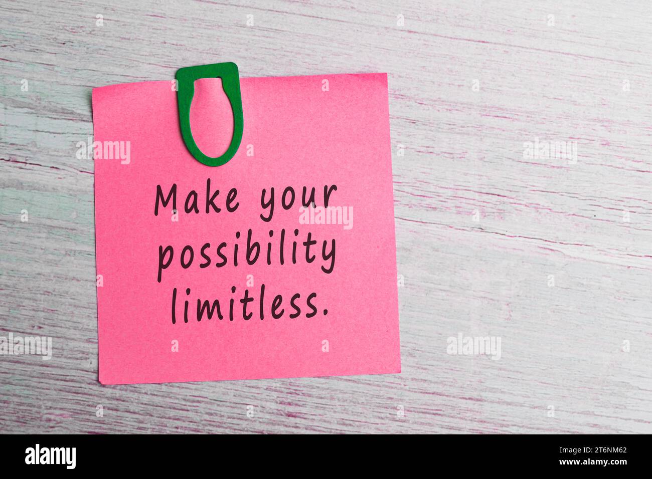 Inspirational quotes on red sticker with paper clip on top of wooden ...