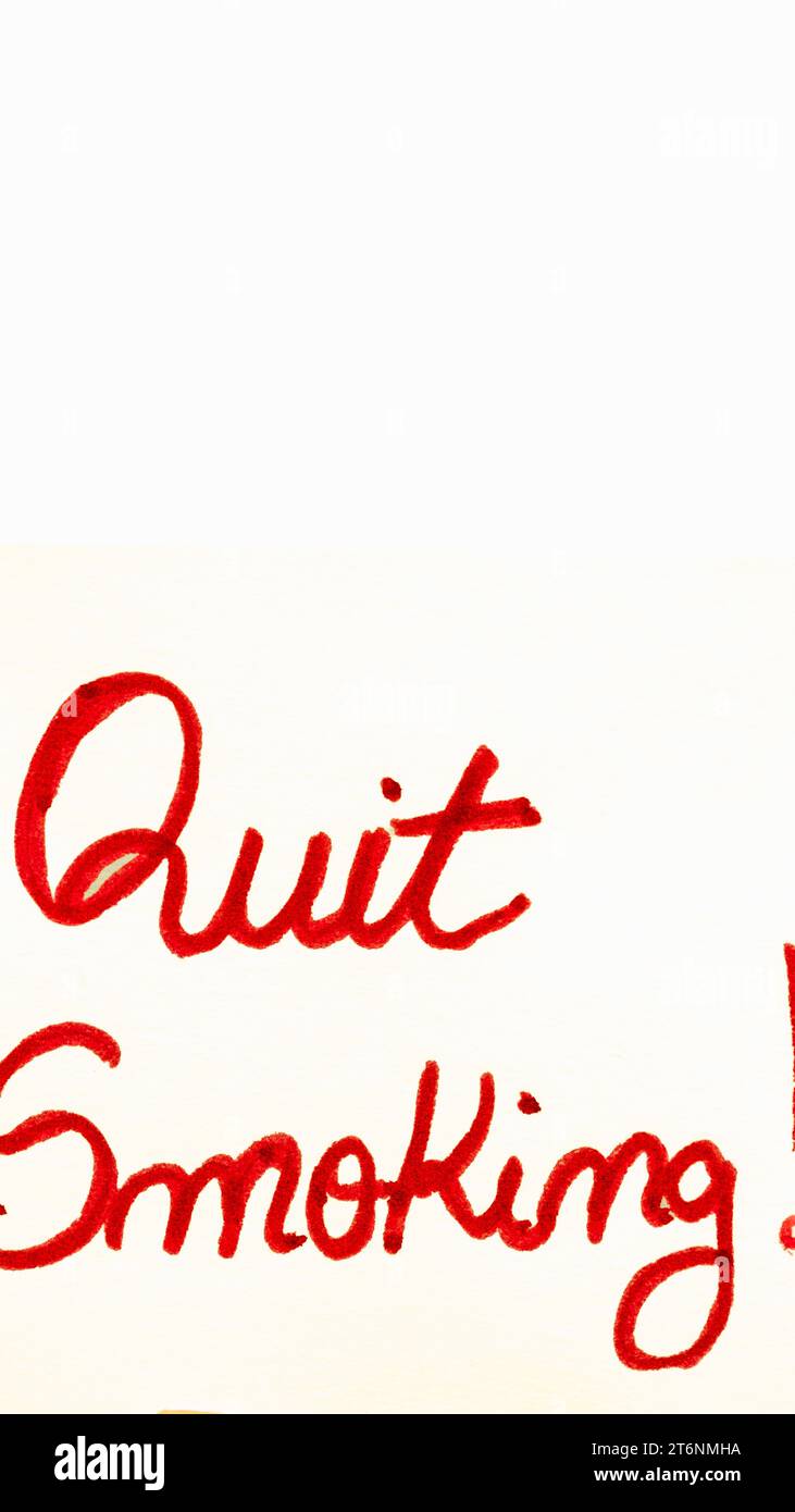 Quit smoking handwriting text close up isolated on yellow paper with ...