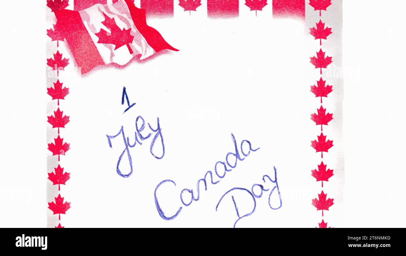 Canada day 1 July handwriting on paper with Canada flag. Writing text ...