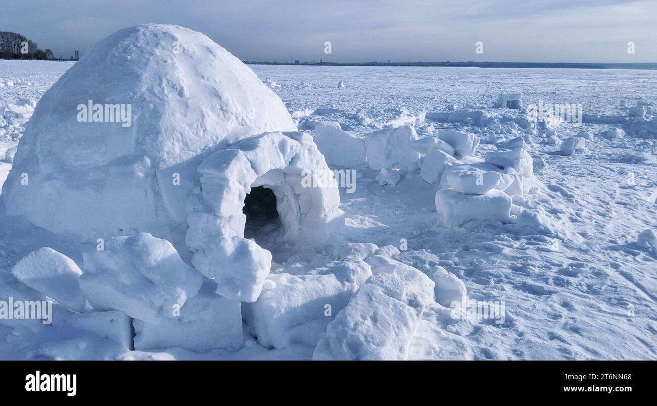 igloo and snow shelter in high snowdrift with mountains peaks on ...