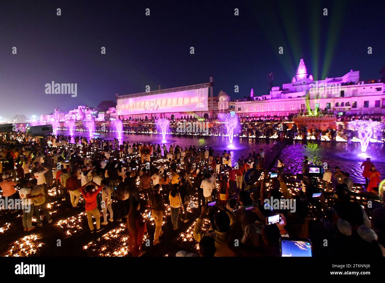 AYODHYA, INDIA – NOVEMBER 11: People lighting earthen lamps at Ram ki ...