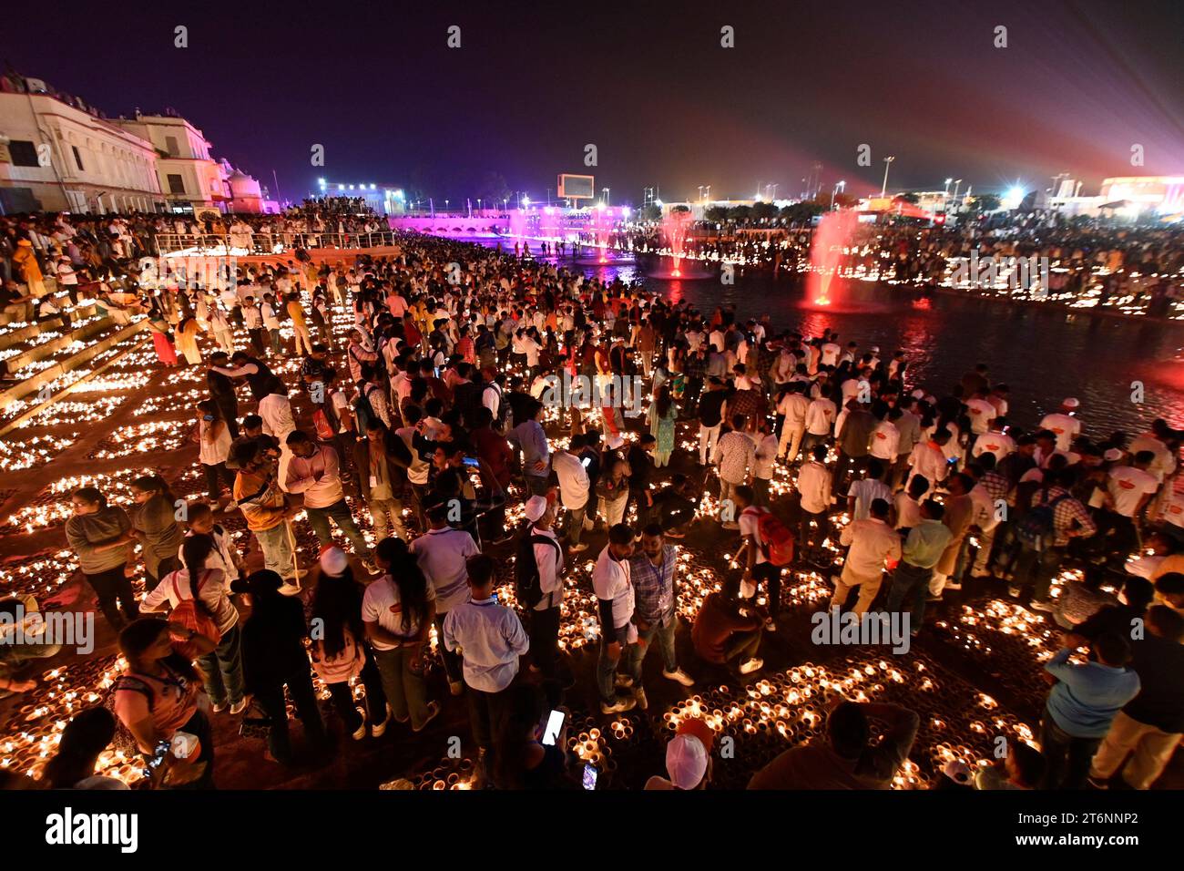 AYODHYA, INDIA – NOVEMBER 11: People lighting earthen lamps at Ram ki ...