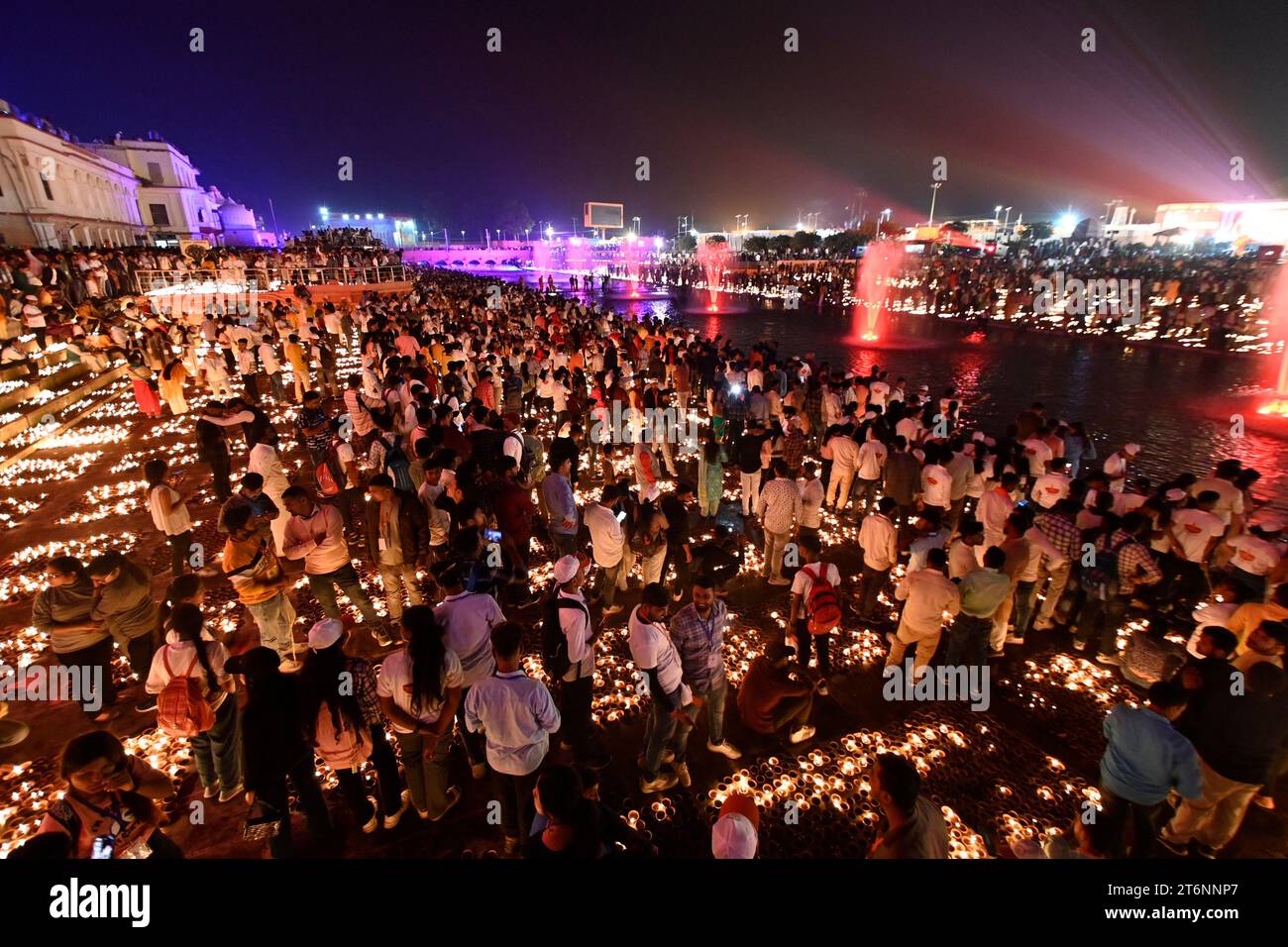 AYODHYA, INDIA – NOVEMBER 11: People lighting earthen lamps at Ram ki ...