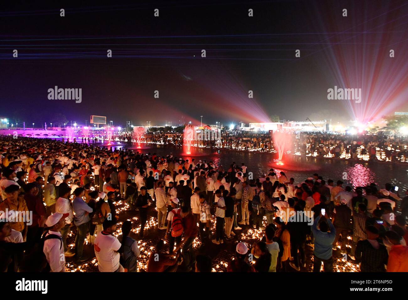 AYODHYA, INDIA – NOVEMBER 11: People lighting earthen lamps at Ram ki ...