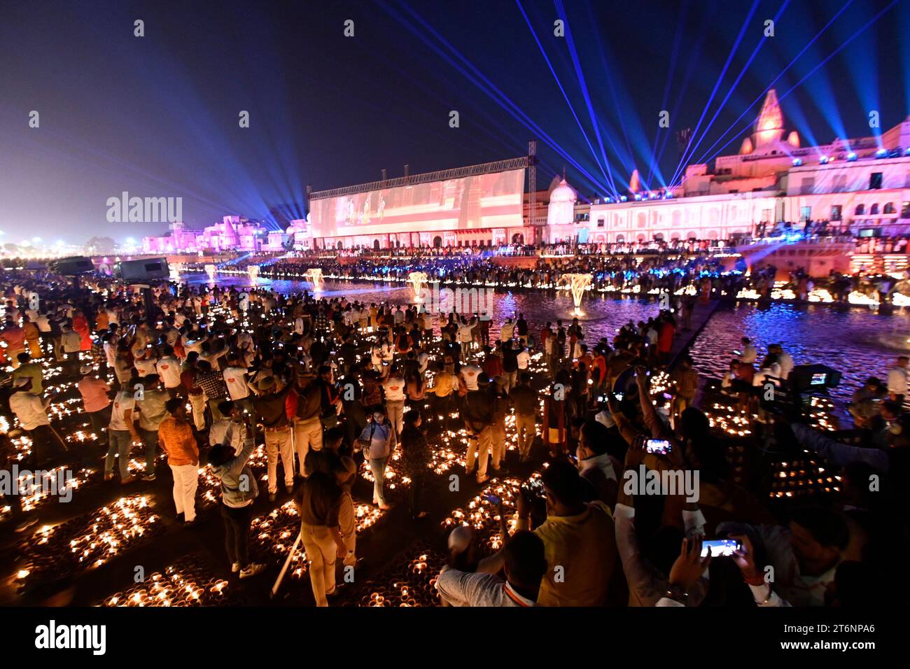 AYODHYA, INDIA – NOVEMBER 11: People lighting earthen lamps at Ram ki ...