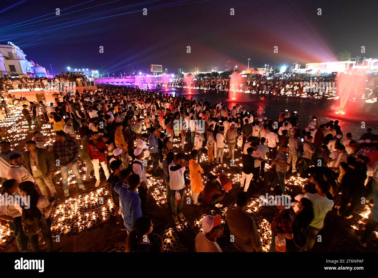 AYODHYA, INDIA – NOVEMBER 11: People lighting earthen lamps at Ram ki ...