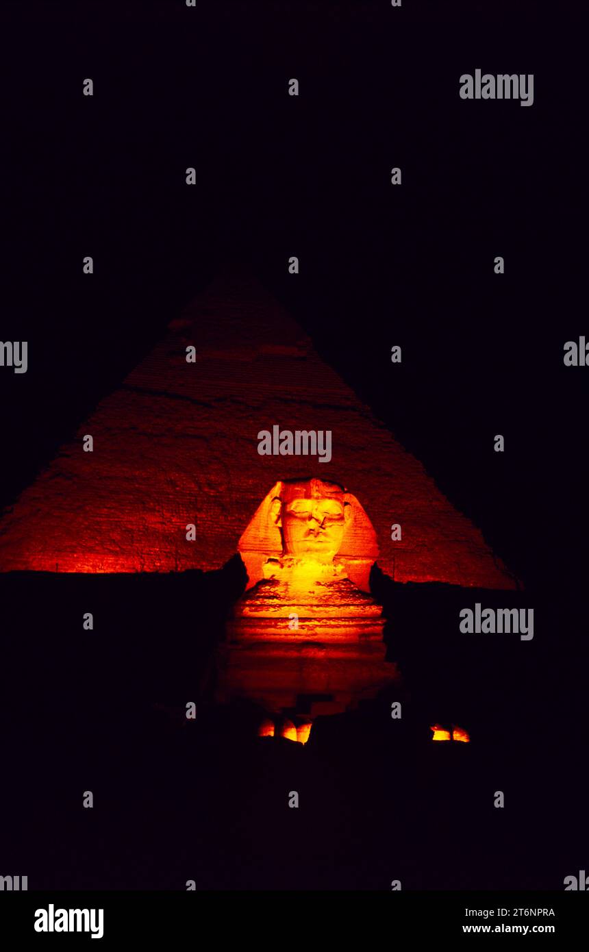 Egypt. Giza. Great Sphinx floodlit at night with Pyramid of Khafre ...