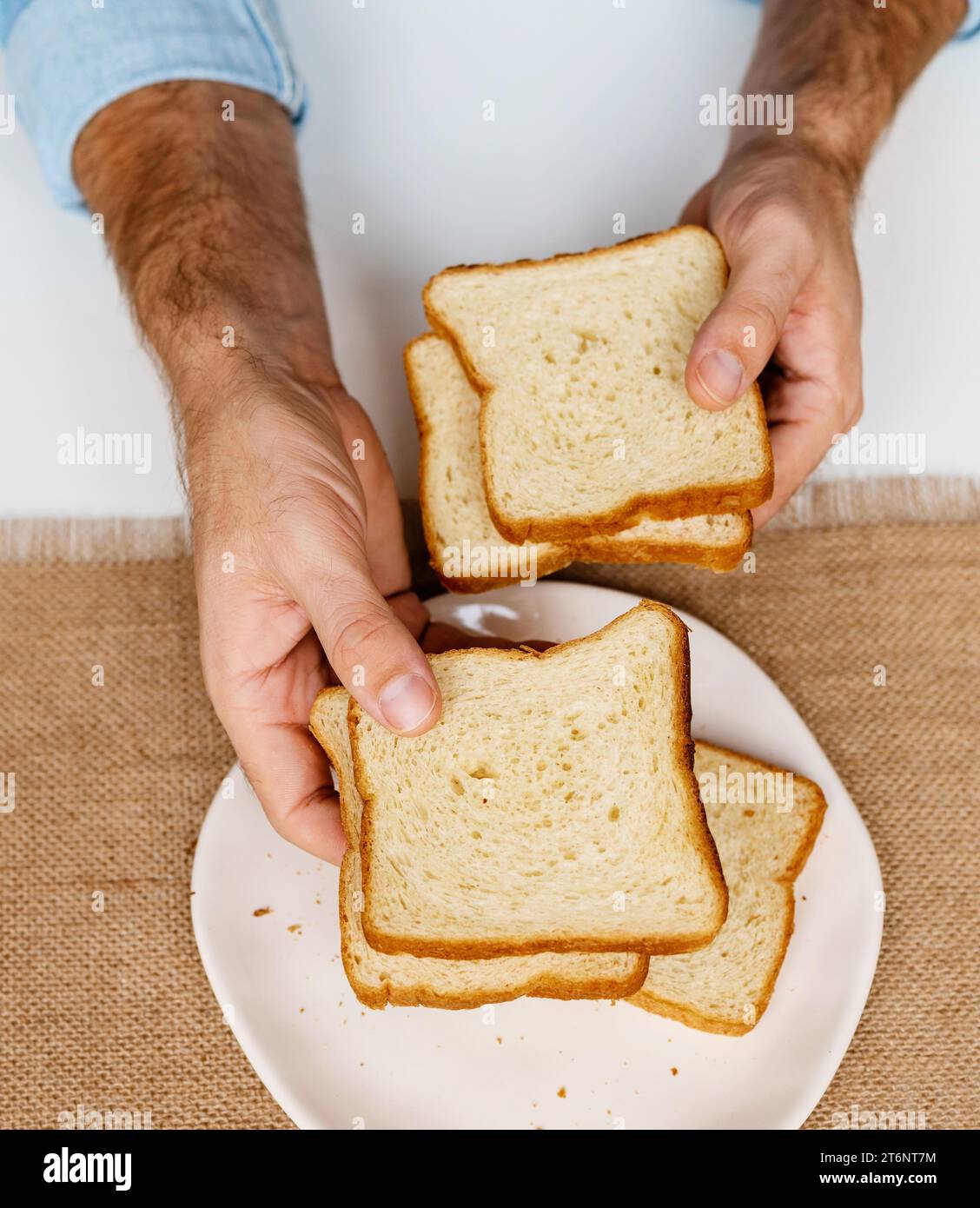 Sandwich bread slices in male hands high angle view Stock Photo - Alamy