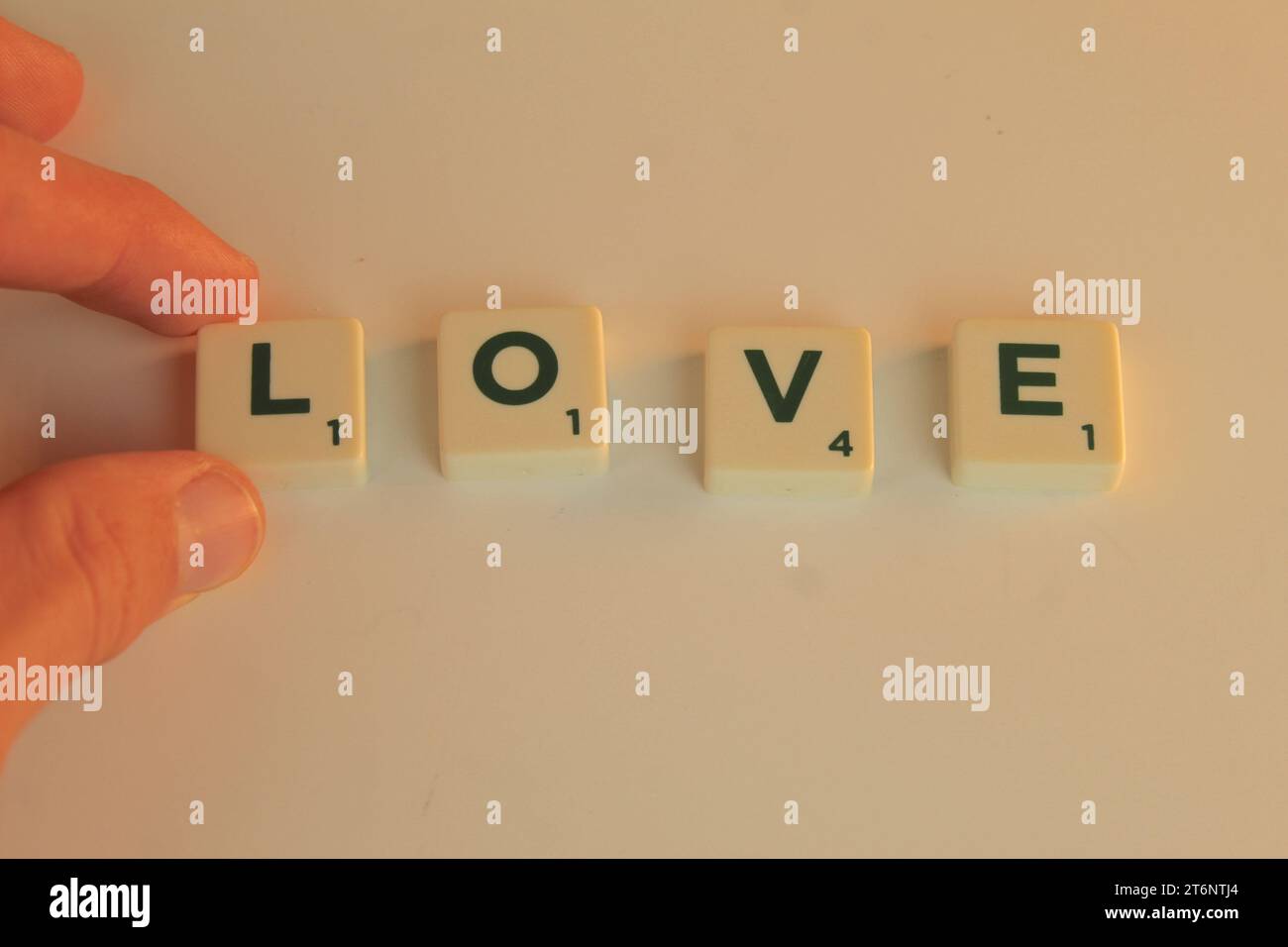 A photo of the word 'Love' spelt out on scrabble tiles Stock Photo - Alamy