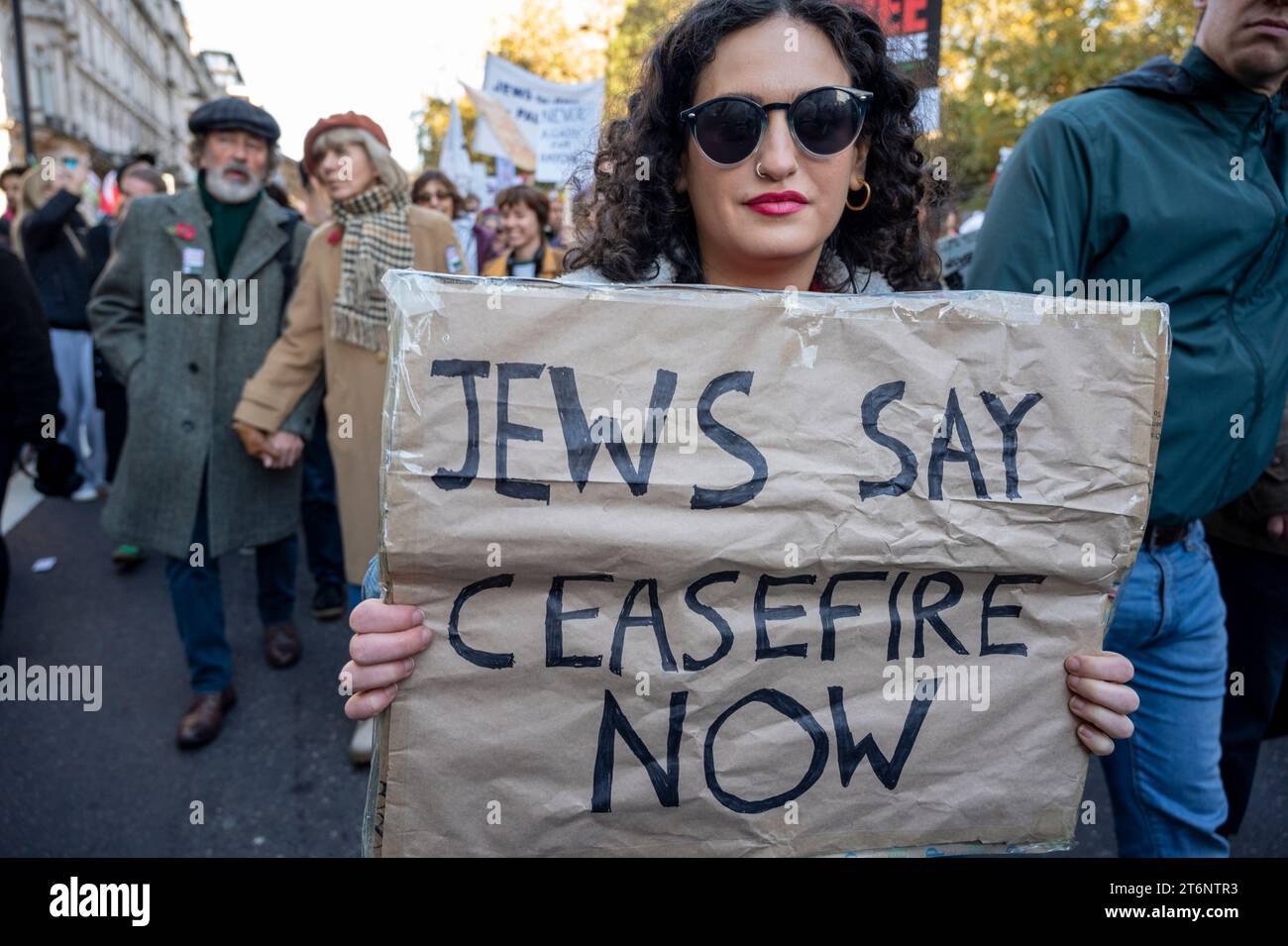 Rally against bombing of Gaza. A young woman holding a placard "Jews ...