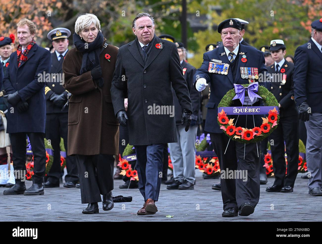 Quebec Premier Francois Legault, centre, lays a wreath alongside his ...