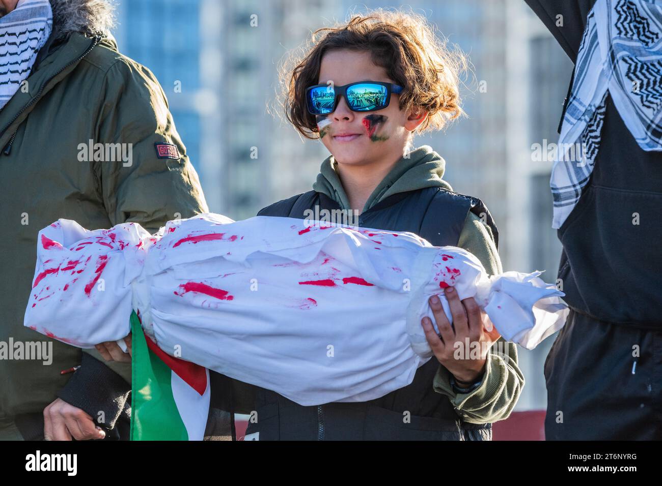 London, UK. 11 Nov 2023. An object is carried in a bloody sheet to ...