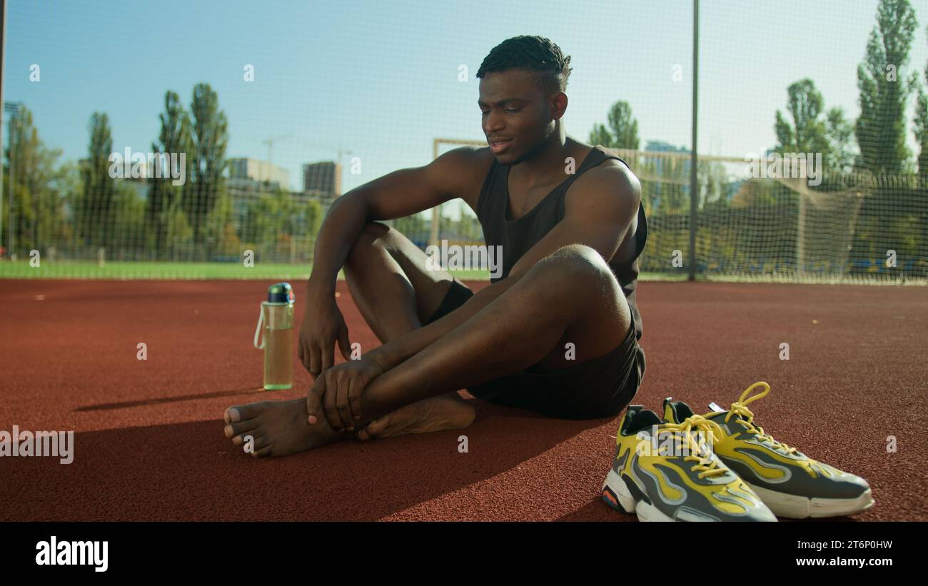 Sad unwell African American man sportsman runner athlete footballer ...