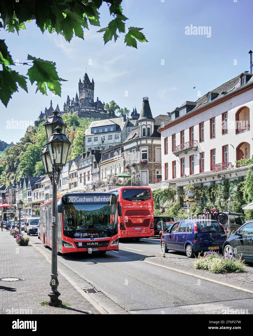 Buses and car traffic on the main street in Cochem Germany with the ...