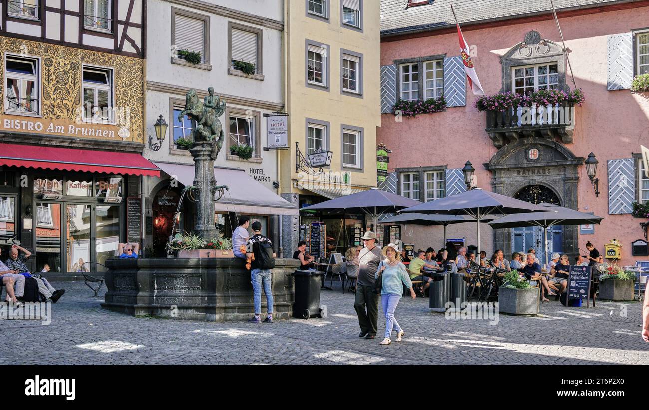 People crowd the pretty old square in medieval Cochem located on the ...