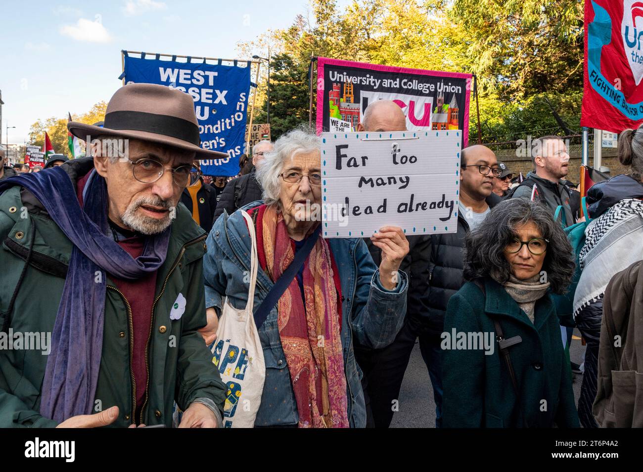 Elderly people with a placard "Far too many dead already". Protest ...