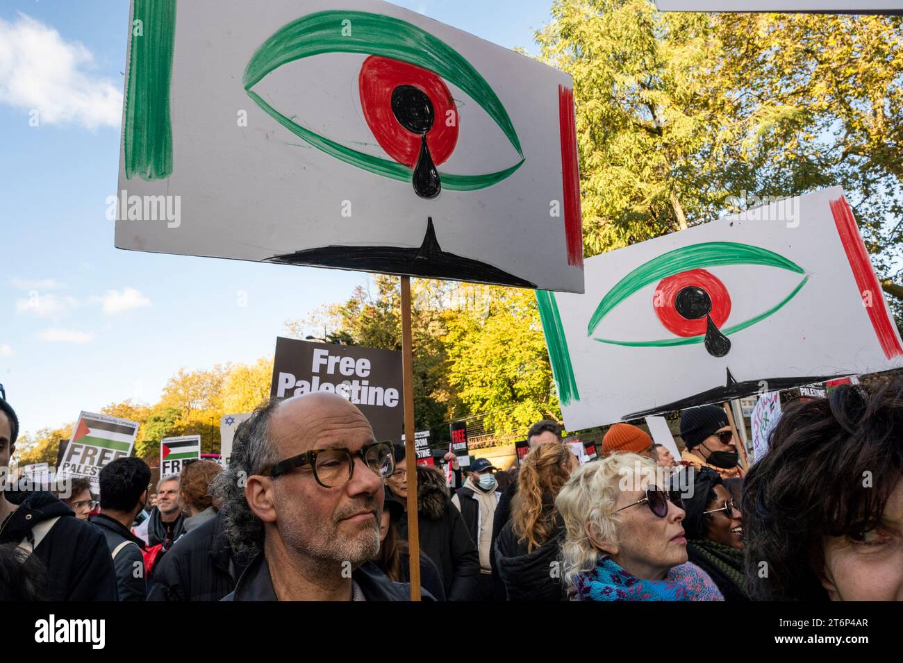 Protesters against the war on Gaza with two placards depicting eyes ...