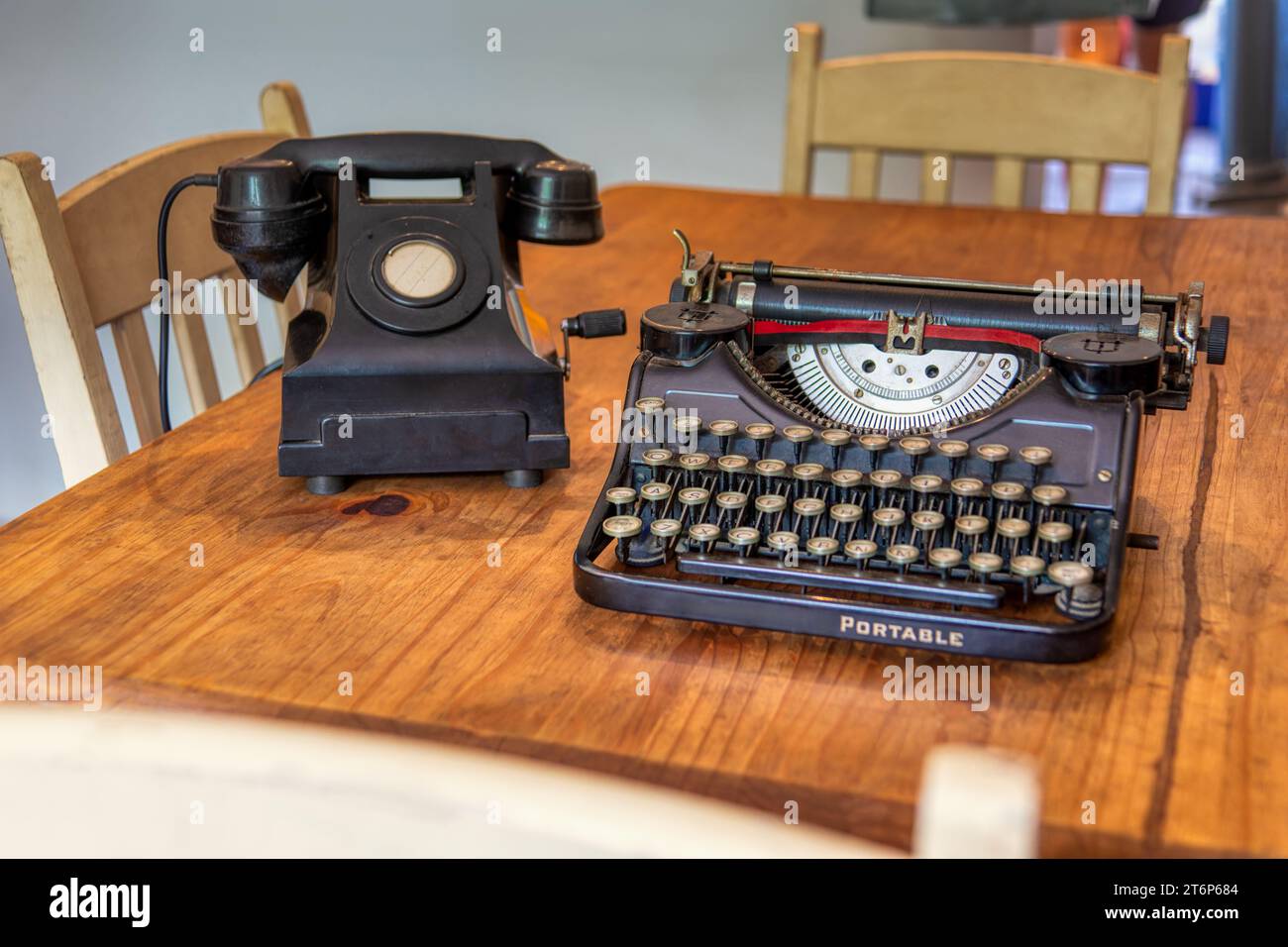 old black typewriter on a vintage wooden table at home , aged rotary ...