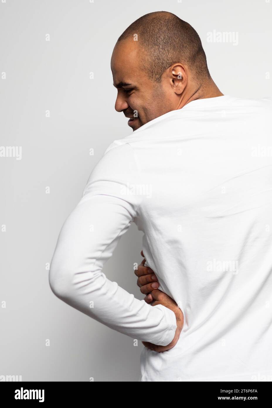 Back view man suffering from side pain Stock Photo - Alamy