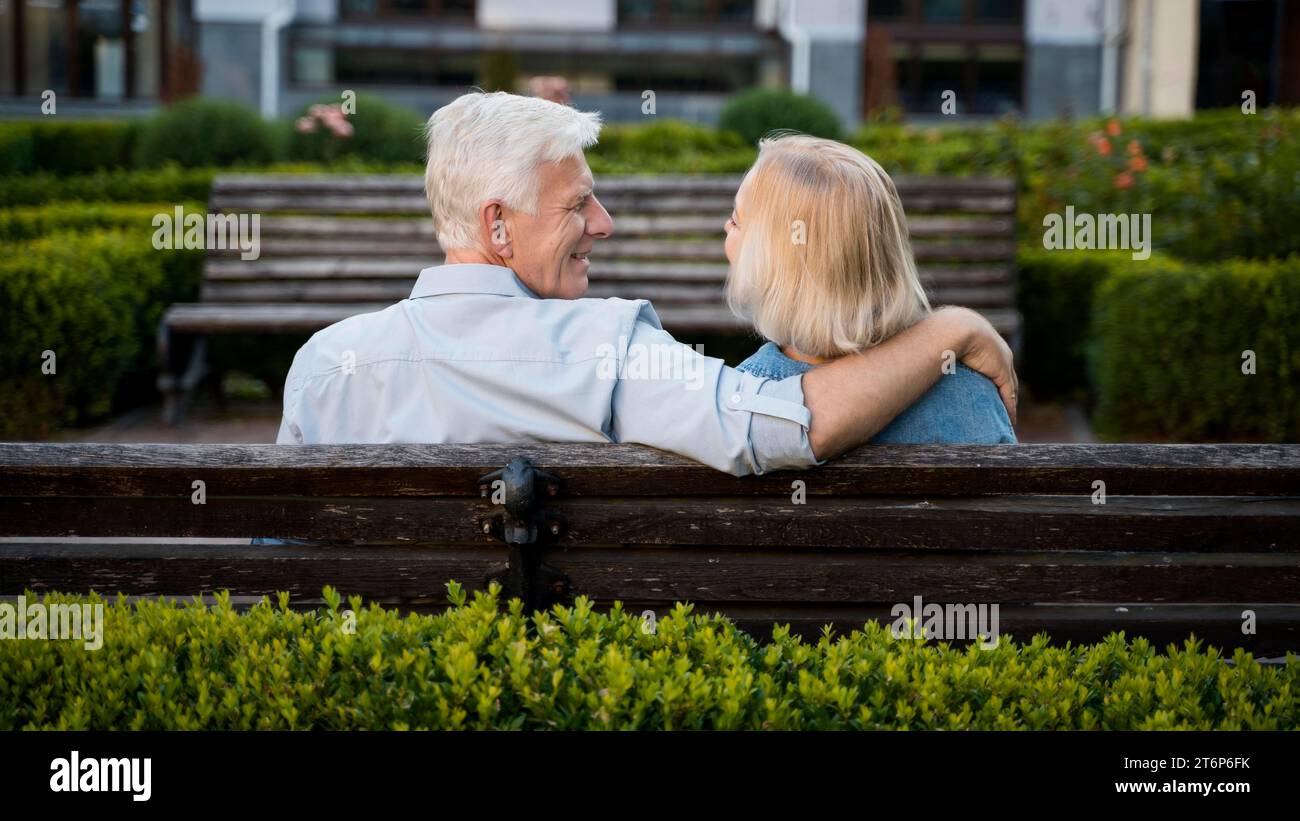 Back view embraced older couple outdoors bench Stock Photo - Alamy