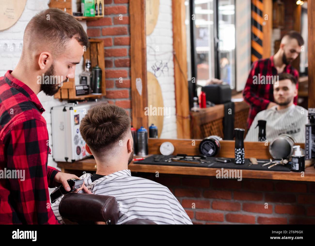 Barber showing haircut customer Stock Photo - Alamy