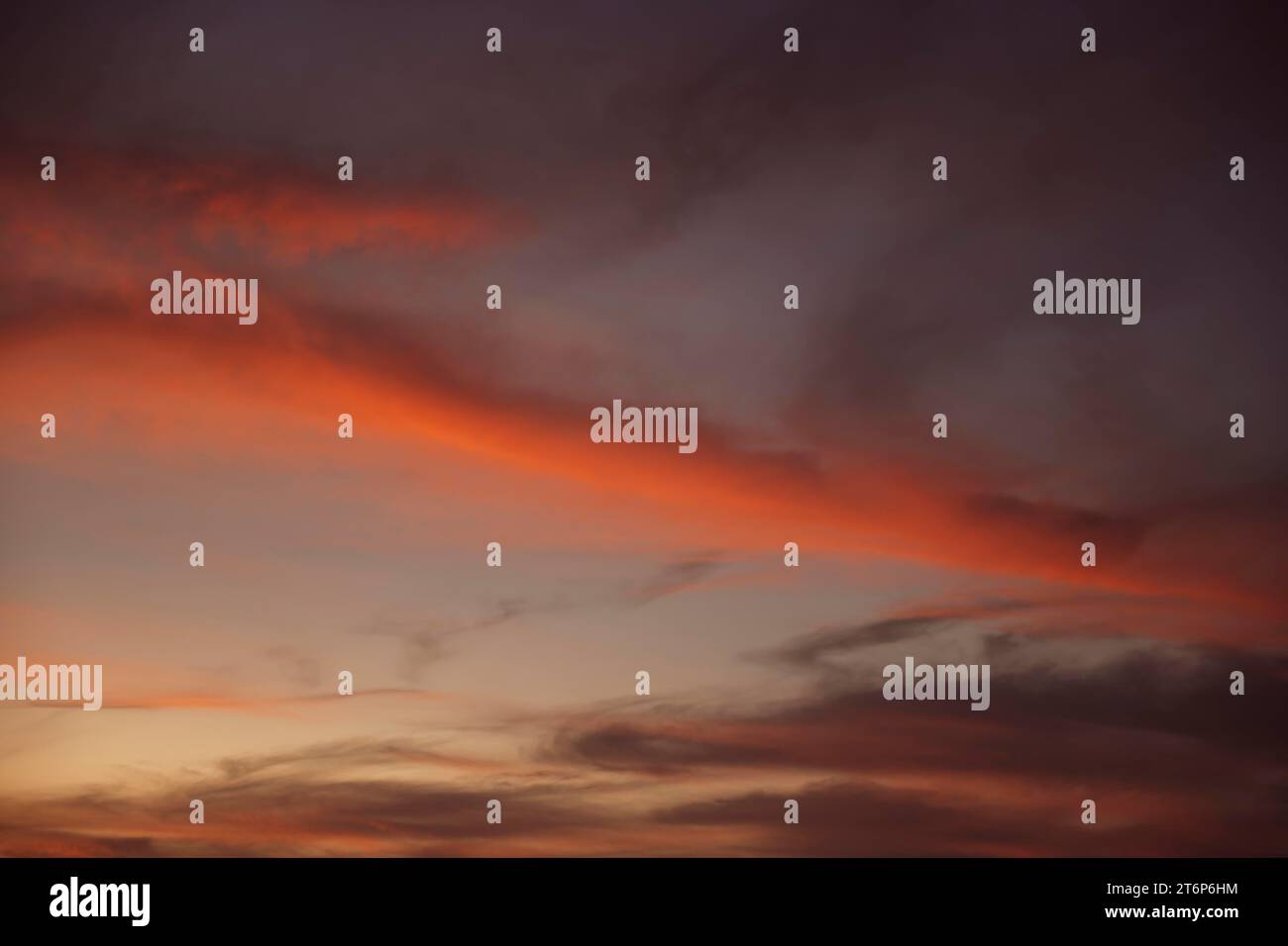 Beautiful clouded night sky with red shades Stock Photo - Alamy