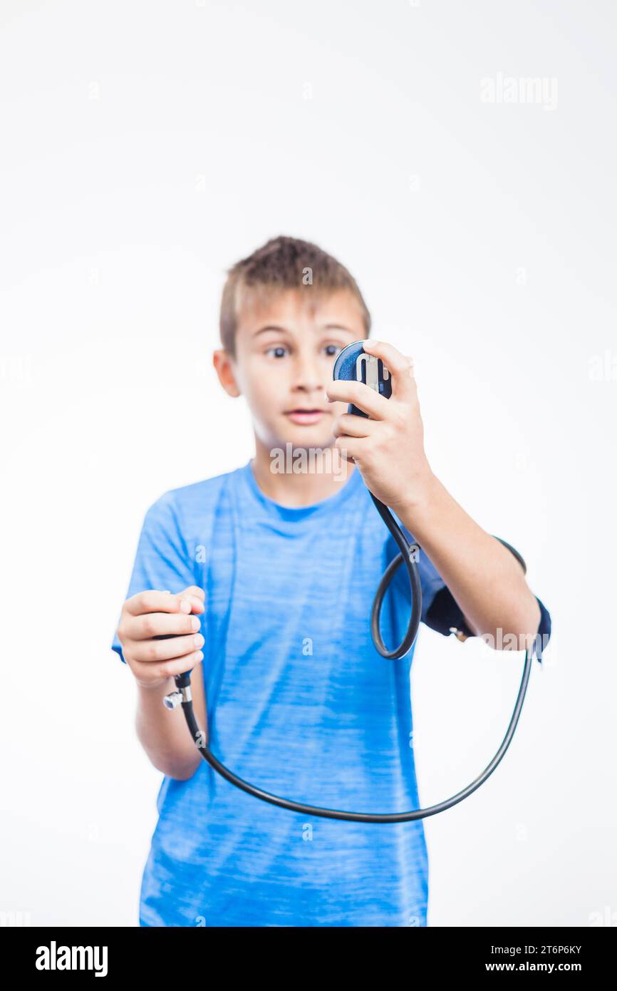 Boy measuring blood pressure white backdrop Stock Photo - Alamy