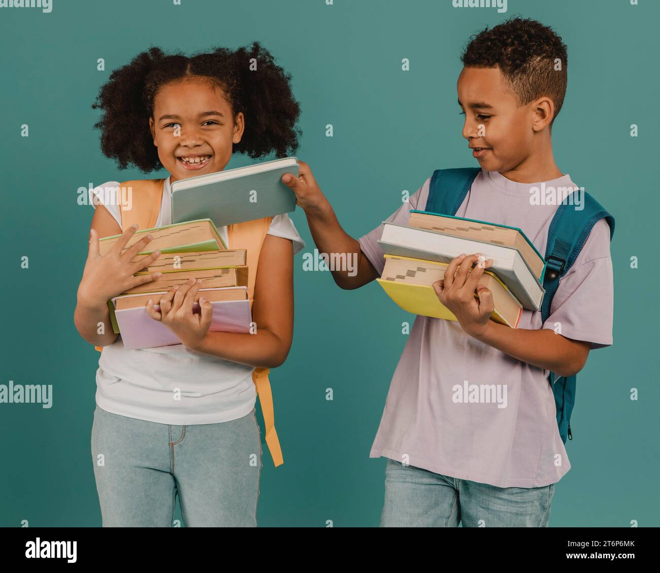 Boy helping his friend with books Stock Photo - Alamy