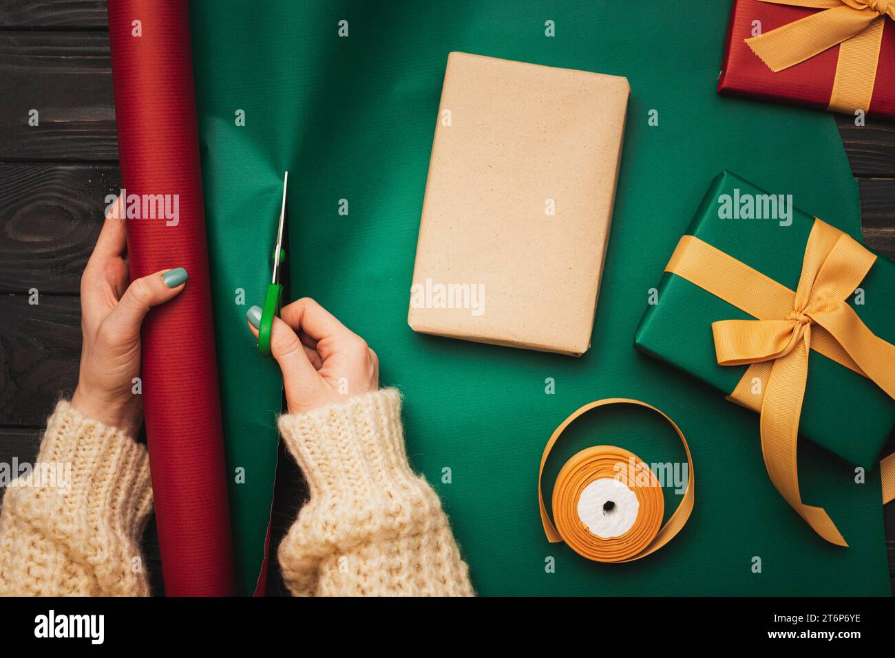 Christmas wrapping paper being cut present Stock Photo - Alamy