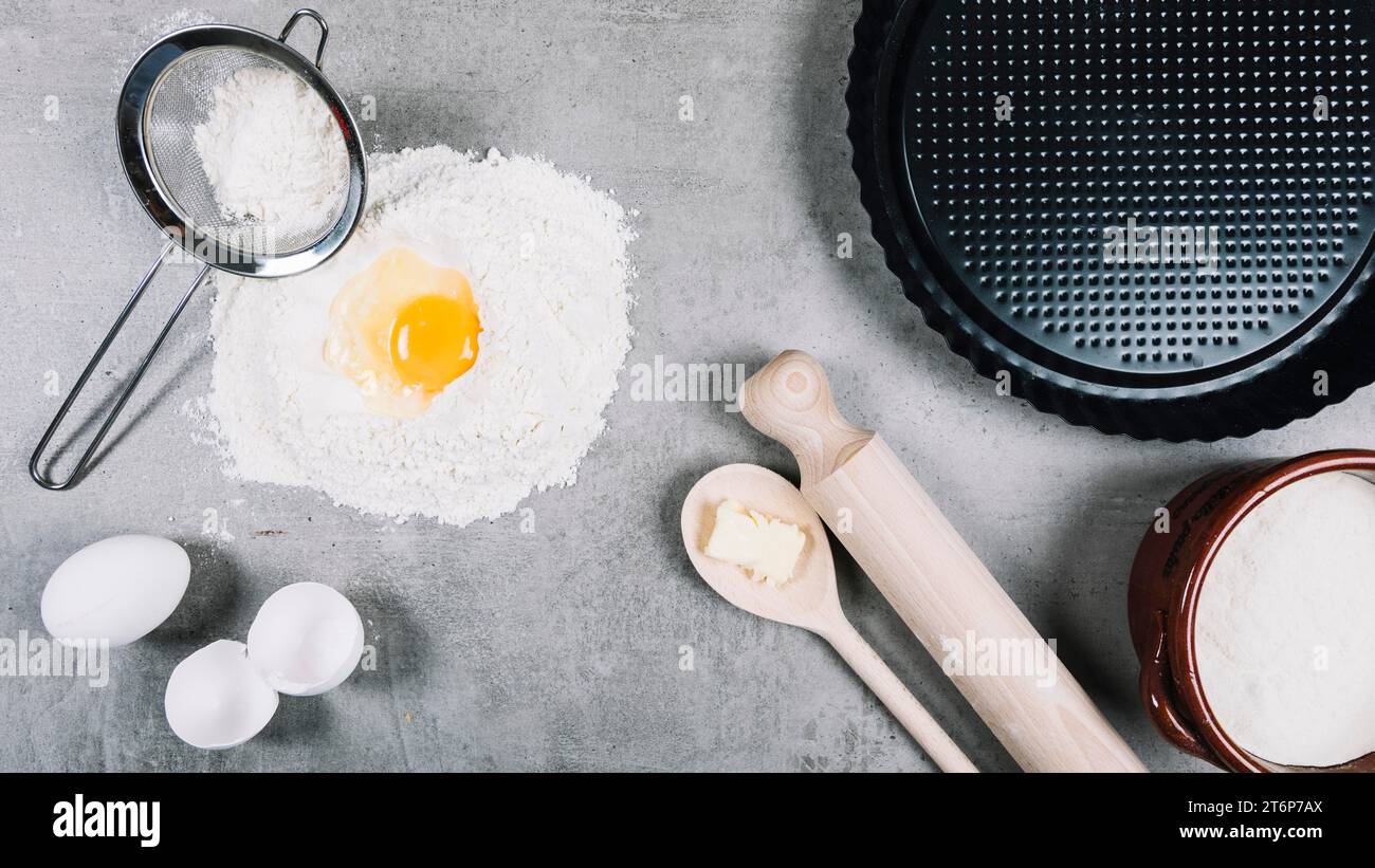 Egg york flour kitchen counter with baking utensil Stock Photo - Alamy