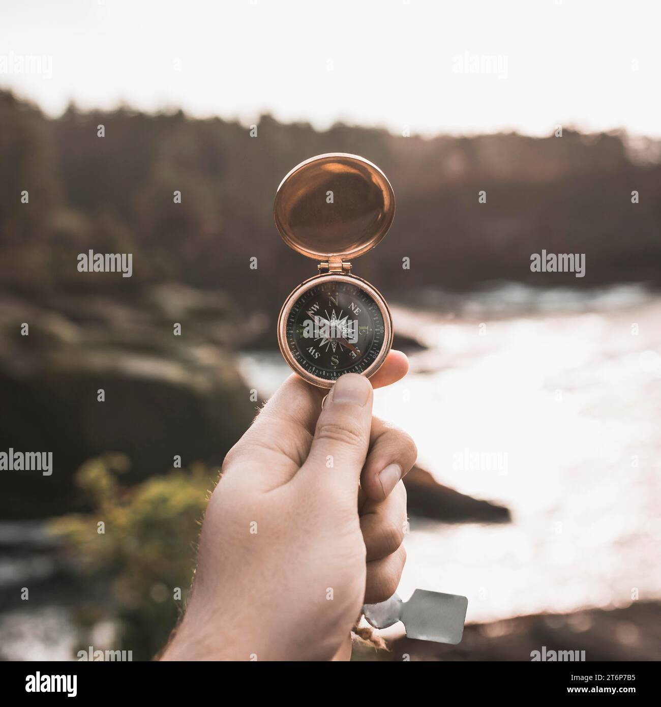 Crop hand with vintage compass Stock Photo - Alamy