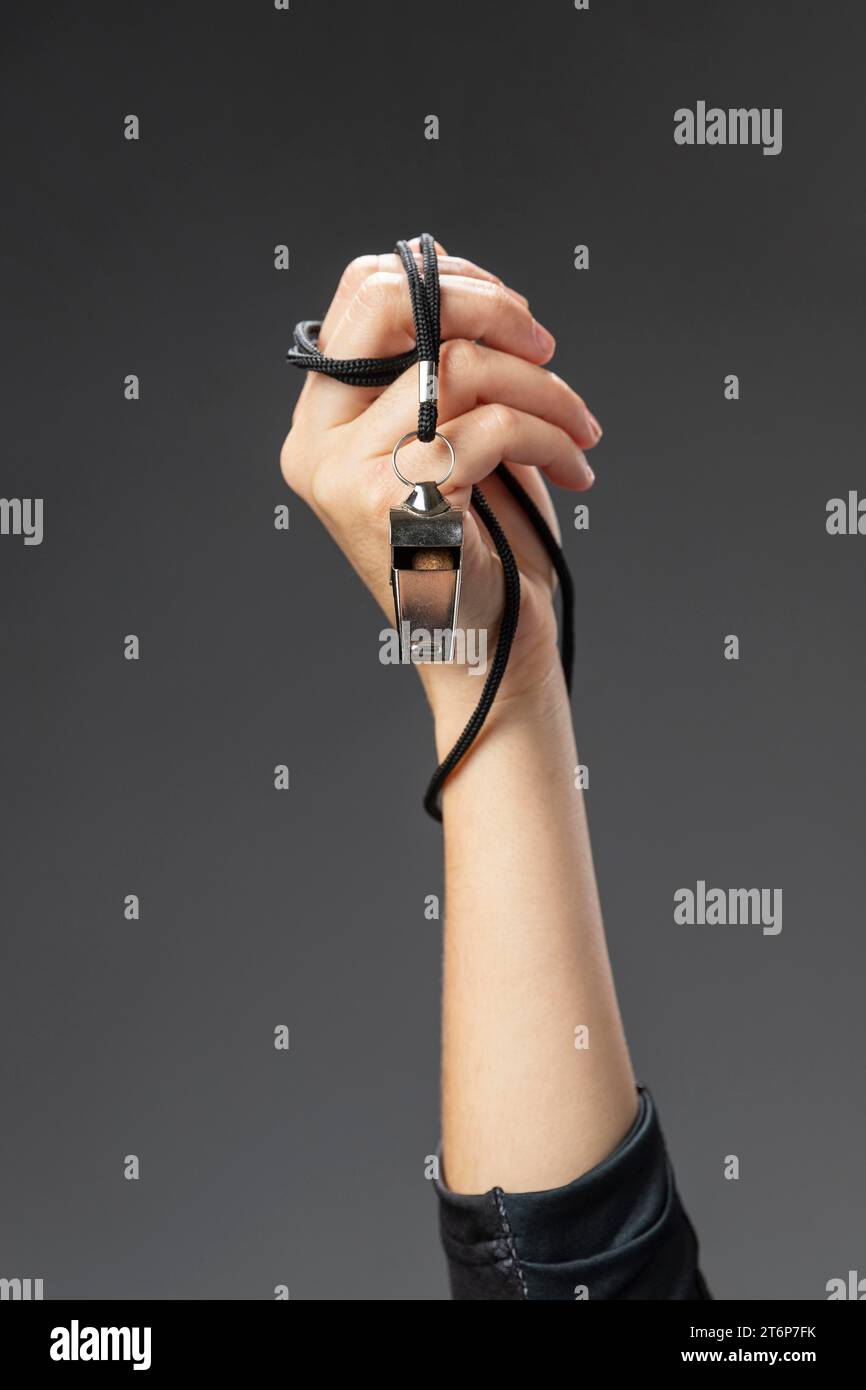 Female referee hand with whistle close up Stock Photo - Alamy