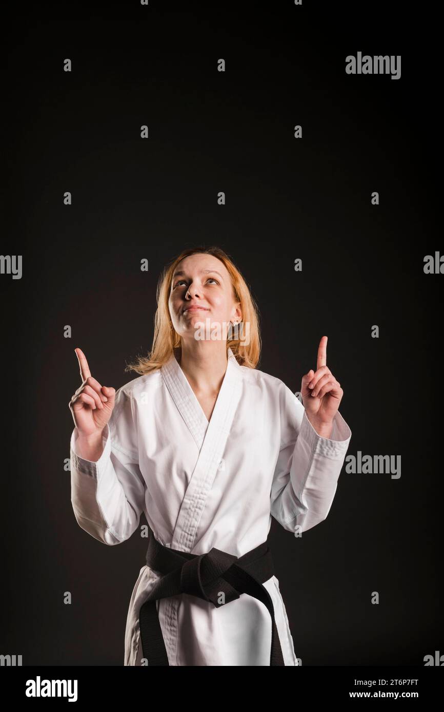 Female fighter pointing up medium shot Stock Photo - Alamy