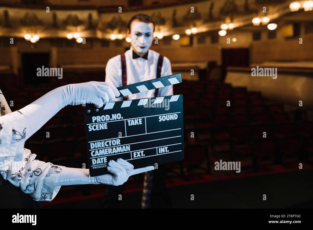 Female mime artist holding clapperboard front male mime stage Stock ...