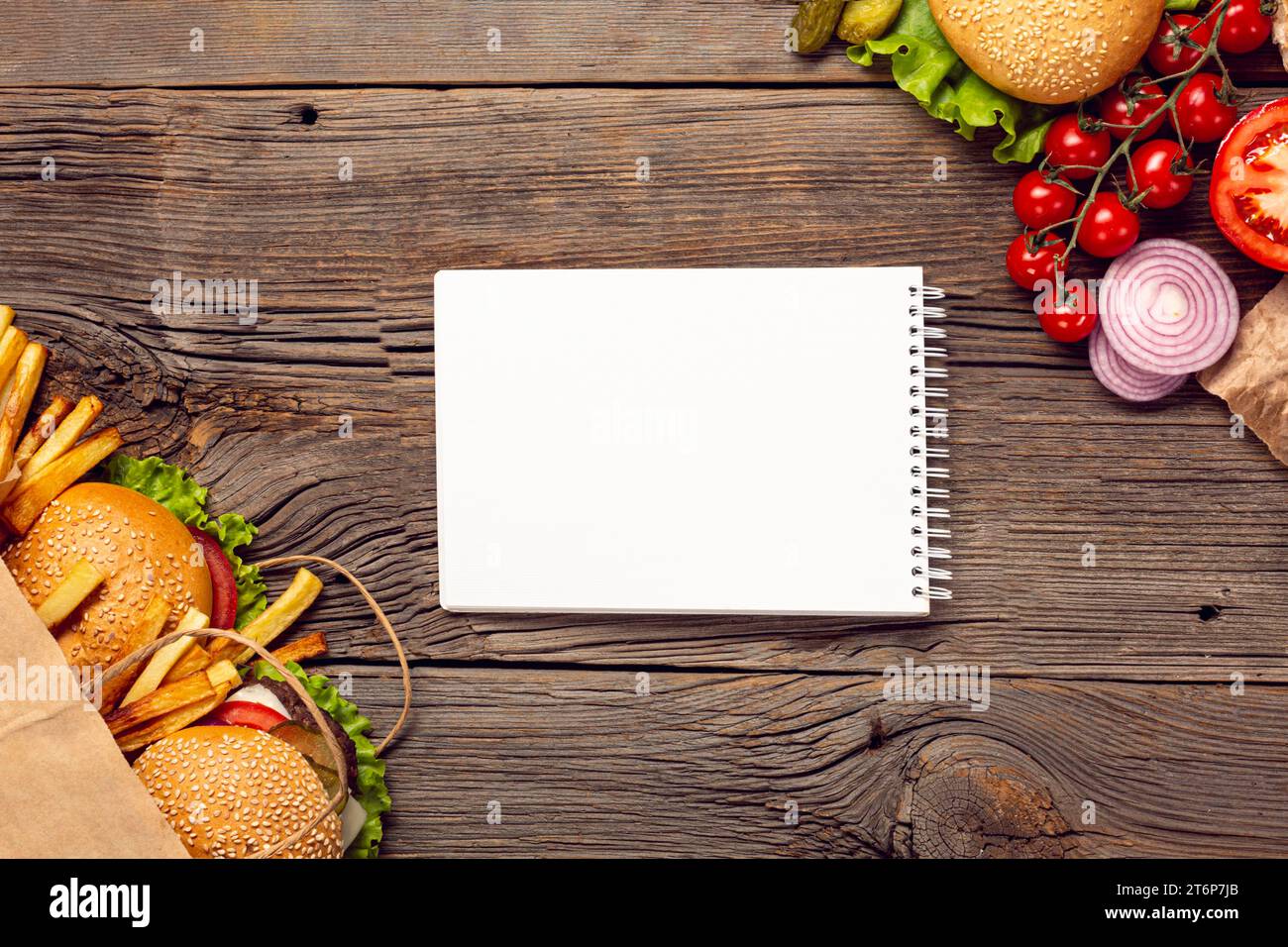 Flat lay burgers with mock up notepad Stock Photo - Alamy